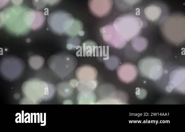 Abstract motion background shining hearts particles. Transparent bokeh. Seamless 4K loop video ...
