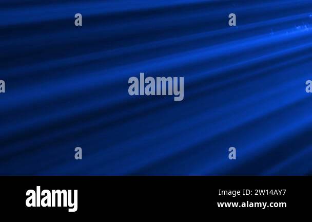 Volumetric rays of light shining from above penetrate through the thick ...