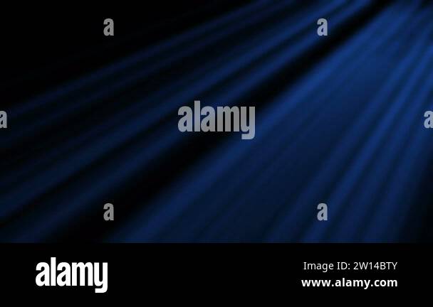 Volumetric rays of light shining from above penetrate through the thick ...