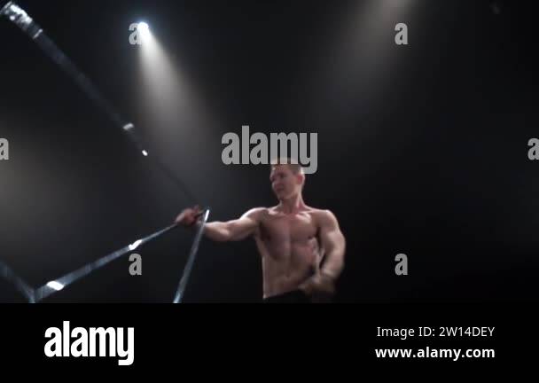 circus male muscular performer making tricks with juggling cube props ...