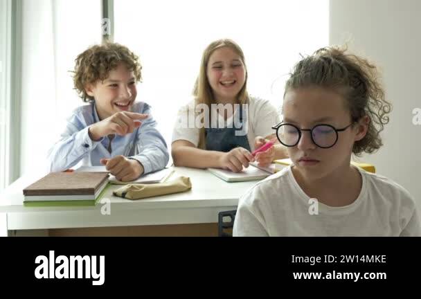 Two teens scoff at their defenseless classmate. Child cruelty. School ...