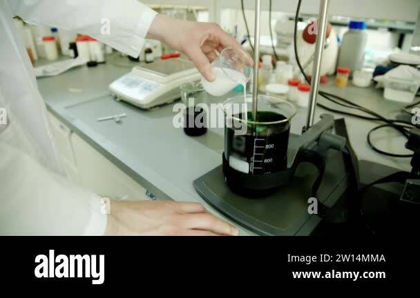 Chemical reaction in chemical laboratory. Mixing liquid reagents in ...