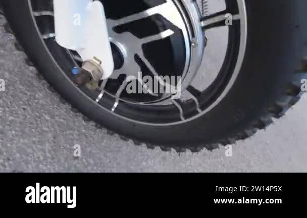 Close up of a front motor wheel spinning under the hood while riding ...