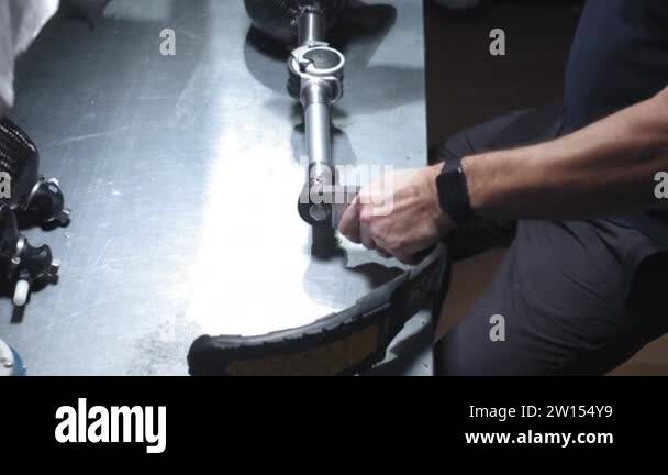 Production of a prosthetic leg. A man creates part of the leg. An ...
