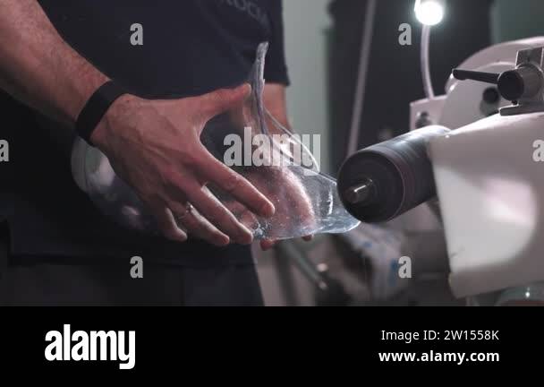 Production of a prosthetic leg. A man creates a part of the leg above ...