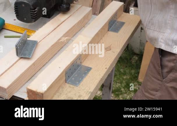 Preparation of boards for construction, men's hands work with wooden ...