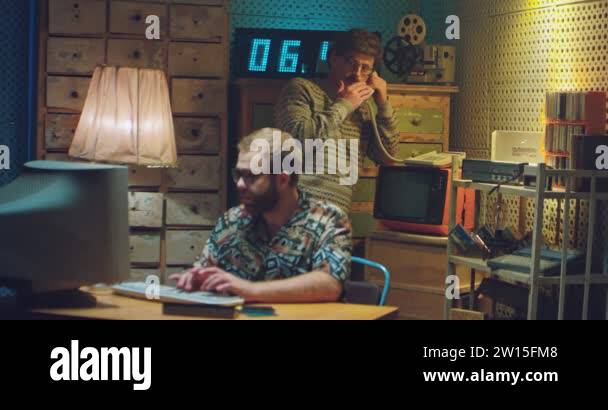 Caucasian young computer programist nerd in glasses sitting at vintage ...