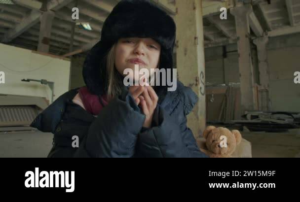 Portrait of a homeless Caucasian girl with grey eyes looking at the ...