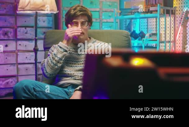 Caucasian funny young man nerd in glasses and with mustache sitting in ...