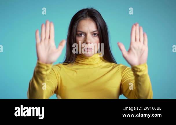 Angry annoyed woman raising hand up to say no stop. Sceptical and ...