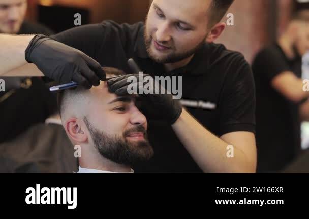 The master makes the contour of the haircut. Mens haircut in a ...