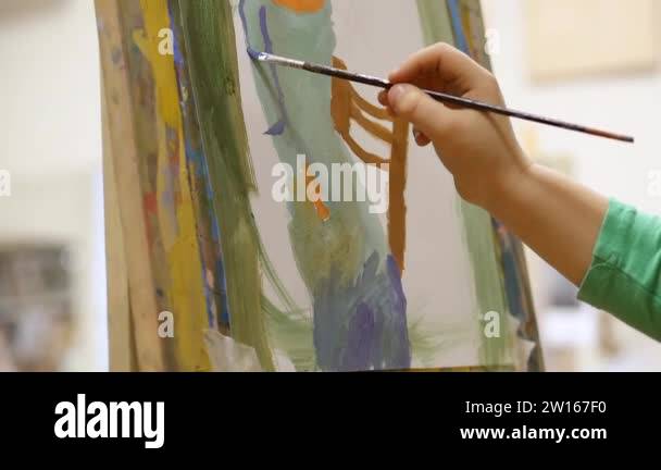 Young Hands of the Artist, Little Girl Artist Paints a Canvas with ...
