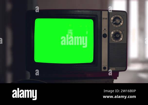 Switch on tuning an old tube vintage TV set than switch off. Wooden ...