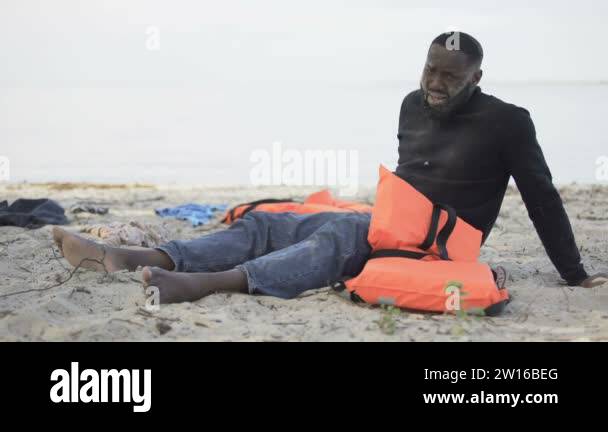 Black man crying hugging life jacket, survived plane crash on deserted ...