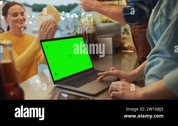 Laptop Computer with Green Screen Mock Up Screen is Placed on a Counter ...