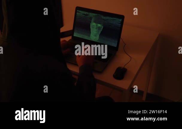 Hacker typing code in a dark room and creating artificial intelligence ...