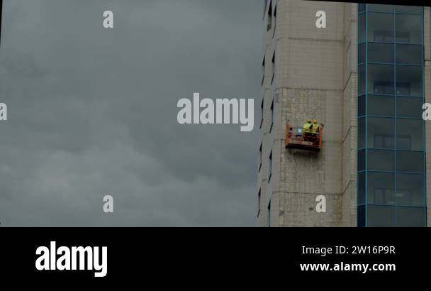 Team of windows cleaner outside the windows of sky scraper building ...