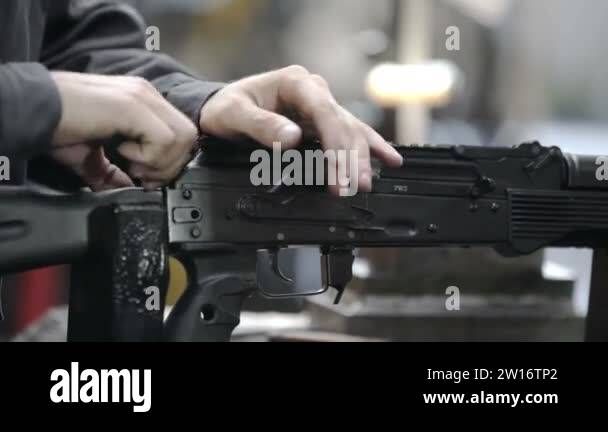 Factory assembly of a Kalashnikov assault rifle. Close up of charging ...