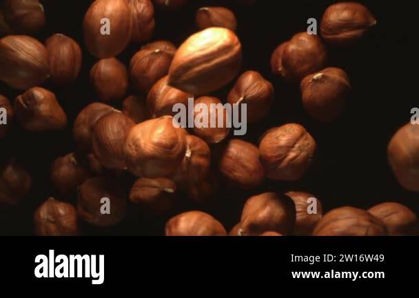 Hazelnut Nuts Flying in the Air in a Free Fall in Slow Motion on Black ...