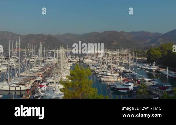 Marina and pier with yachts, seaside town on the beach, hotel and ...