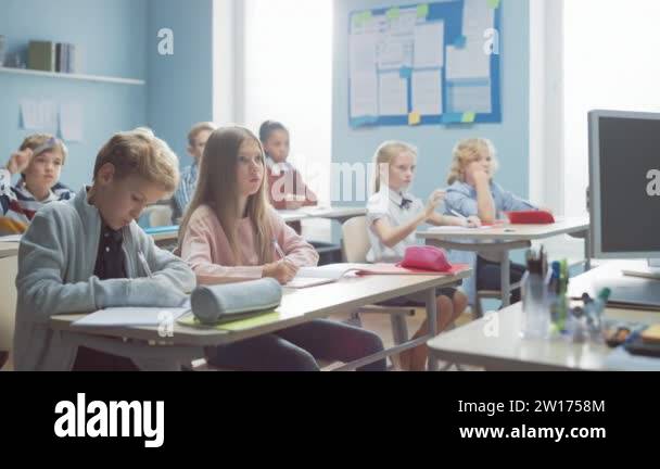 Elementary Classroom of Children Listening Attentively to their Teacher ...