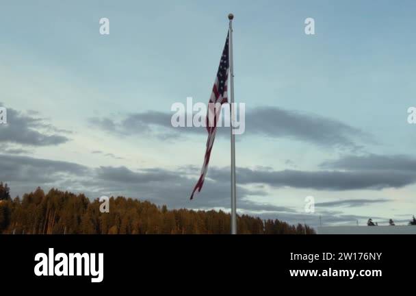 american flag waving at the top of a tall flag pole Stock Video Footage ...
