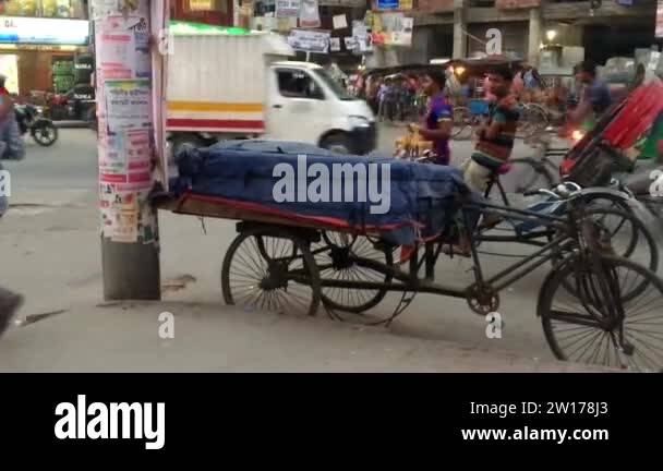 Unidentified people and street traffic at the Ring Road in the Adabor ...