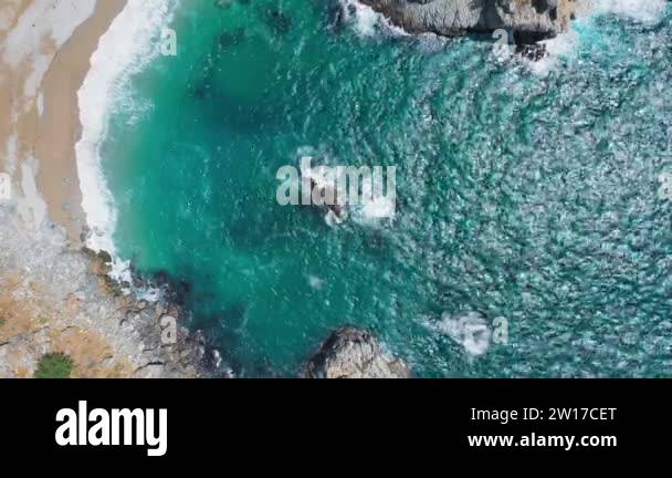 4K bird-eye view of gorgeous cove with stunning bright green clear ...