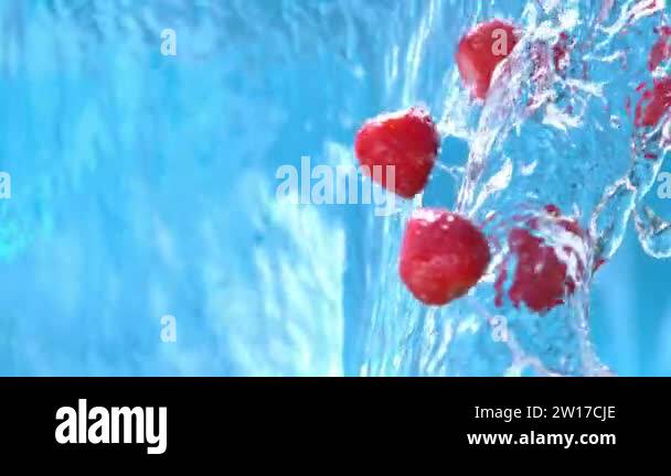 Ripe Strawberry Falling into Water Splash Cascade in Slow Motion Shot ...