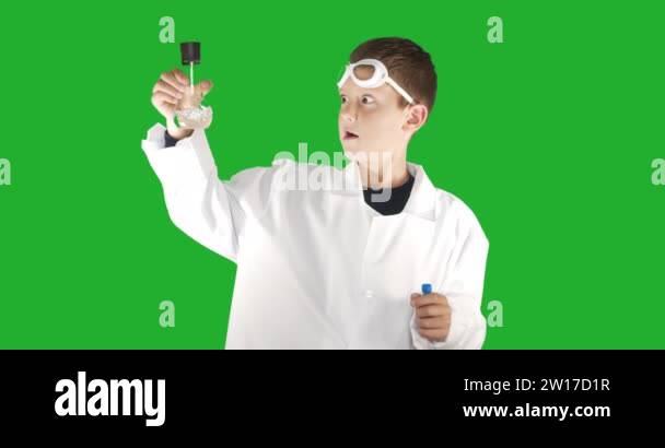 Portraitof a school boy chemist doing an experiment in a flask , on ...