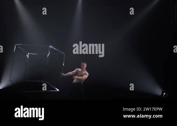 circus male muscular performer making tricks with juggling cube props ...