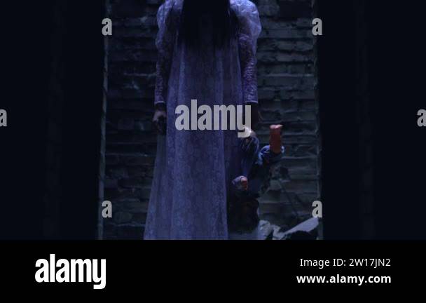 Scary bride ghost holding creepy doll in dark abandoned building ...