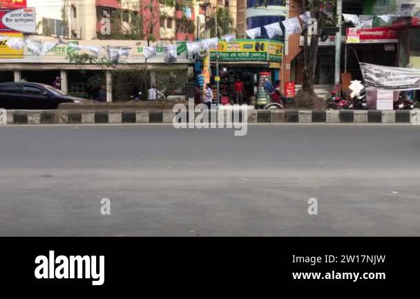 Unidentified people and street traffic at the Ring Road in the Adabor ...
