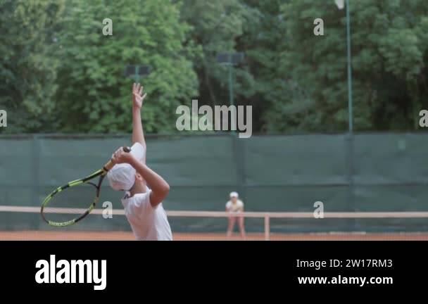 tennis game, sports player adolescent boy with contestant hitting ...