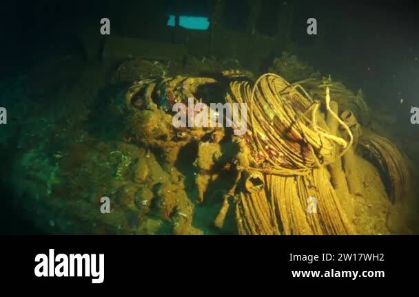 Diver inside hull of sunken ship underwater of Pacific Ocean on Chuuk ...