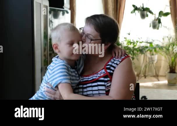 Grand son cute boy hugging and kiss senior woman, grandmother. Happy loving family Stock Video ...