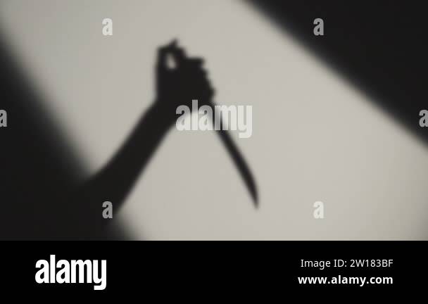Hand of Killer Stabbing Victim with a Knife. Crime Scene. Dark Shadow ...