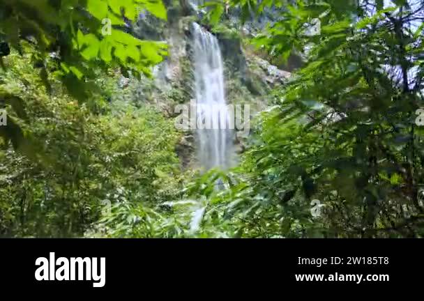 Beautiful waterfall falling down the mountainside in the majestic Grand ...