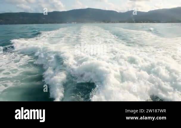A slow motion view of the wake behind a large cruise ship at sea. Ship ...