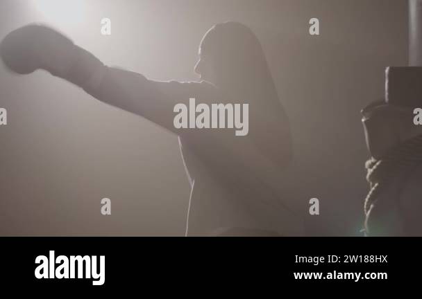 Side view silhouette of muslim woman boxing shadow in slow motion in ...