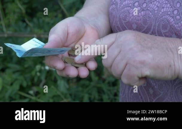 Mature older female counts money in her wallet. Old retired woman ...