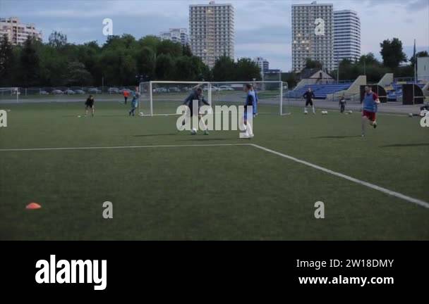 Football club training. Athletes play soccer at the city stadium and ...