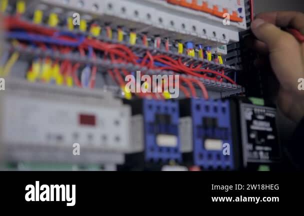 Electrician testing electrical power. Industrial factory electrician ...