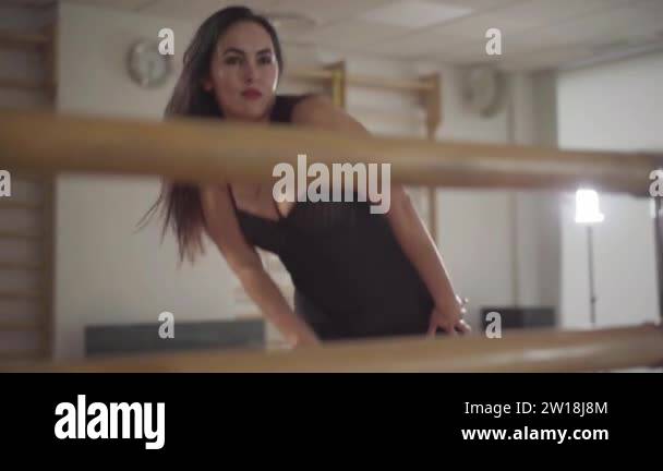 Reflection in mirror of gorgeous Caucasian woman dancing strip plastic in gym. Beautiful young ...