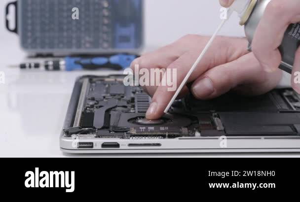 Service worker repairing cleaning dust laptop motherboard circuit board ...