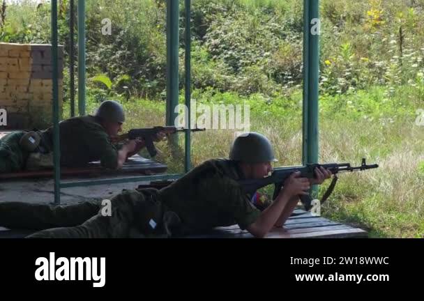 MOSCOW - JULY 30. Soldiers shoot from an AK-47 machine gun at targets ...