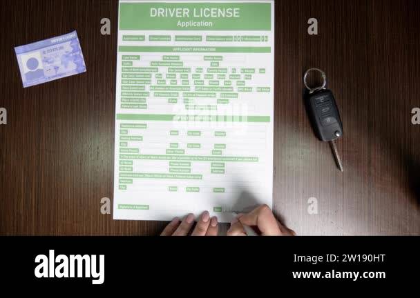 Woman filling in driver license application at table, top view Stock ...