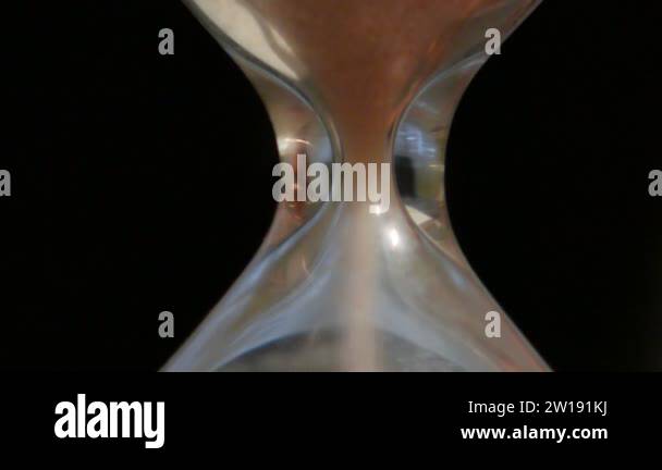 Hourglass counting the time in extreme close-up, black background Stock ...
