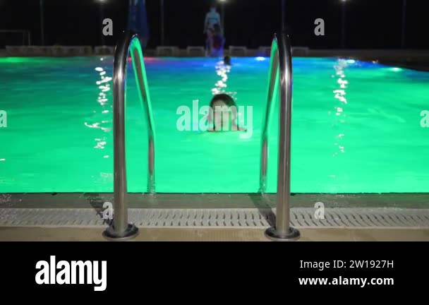 Sexual Girl Into Swimsuit Comes Out Water Holding To Poolside Ladder In Evening Stock Video
