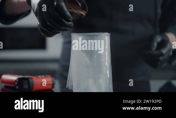 Chef fills the pastry bag with hot melted chocolate in slow motion, raw ...